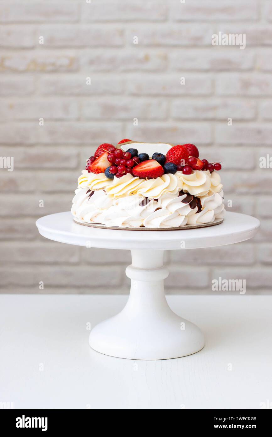 Pavlova cake with whipped cream cheese, chocolate sauce and fresh ...