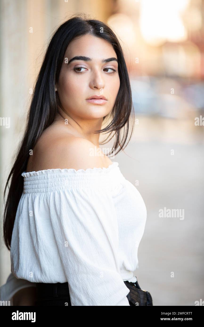 Woman looking over shoulder unhappy hi-res stock photography and images ...