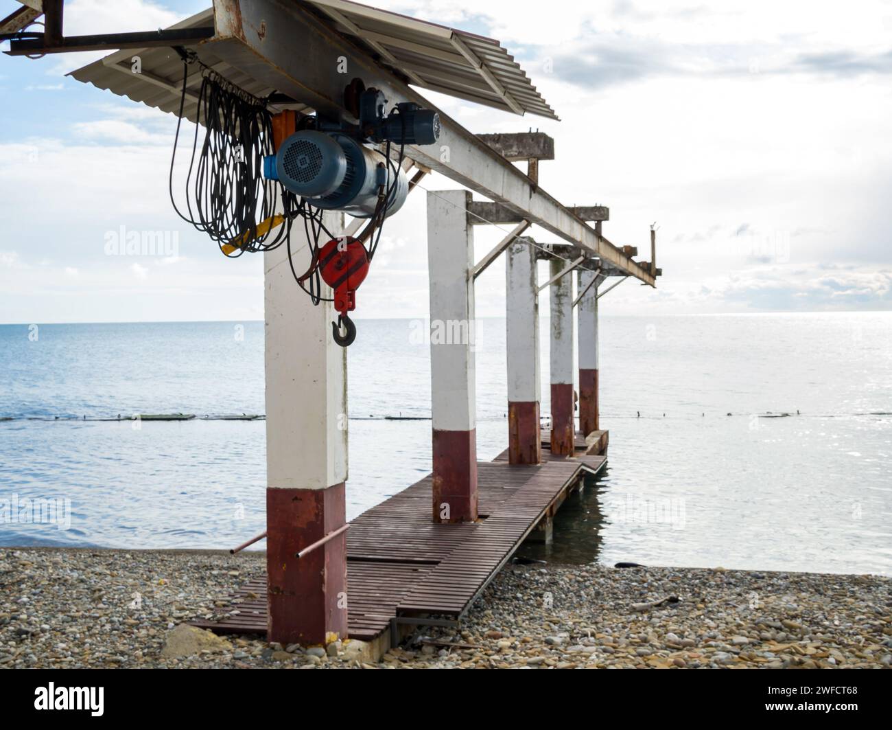 Pier with electric winch for lifting boats Stock Photo - Alamy