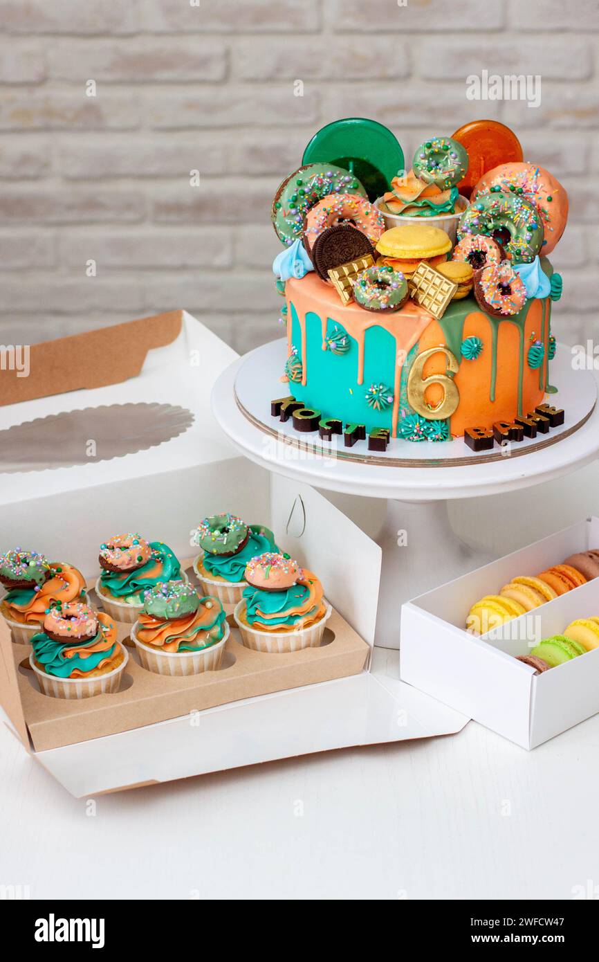 Delicious two-sided birthday cake made in green and orange colors ...