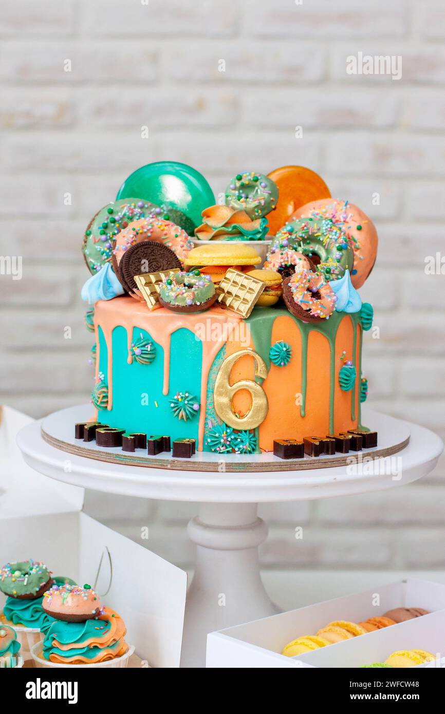 Delicious two-sided birthday cake made in green and orange colors ...