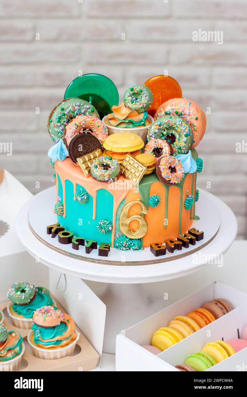 Delicious two-sided birthday cake made in green and orange colors ...