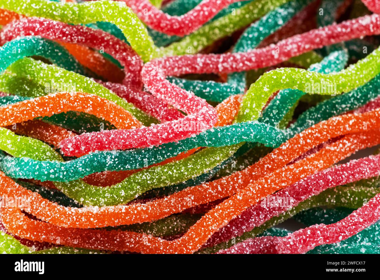 Multicolored jelly candies in the shape of the spaghetti sprinkled with ...
