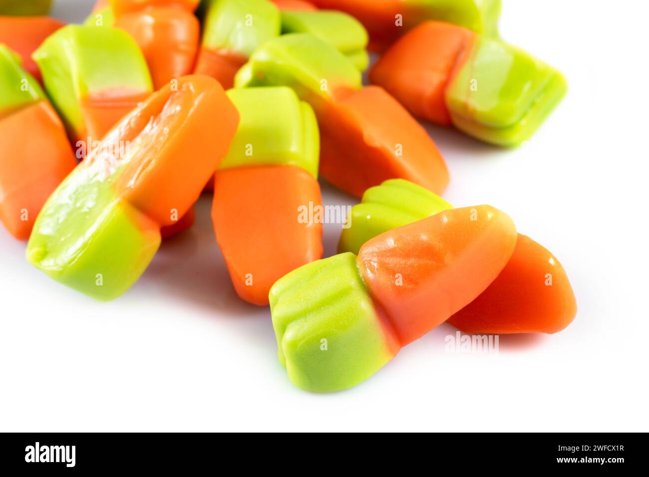 jelly carrots candies on a white background. Colorful fruit gum candies ...