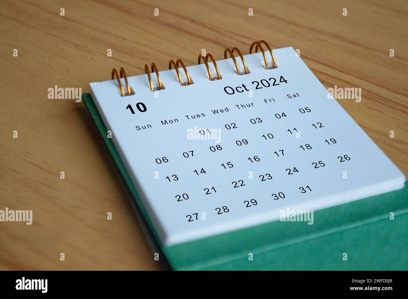 Close up side view of October 2024 calendar on wooden desk. Calendar ...
