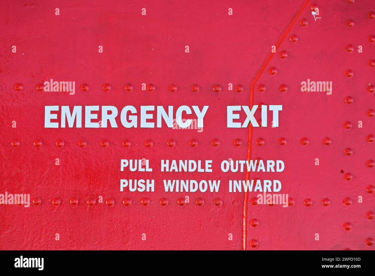 Emergency exit sign and instructions on outside of old passenger ...