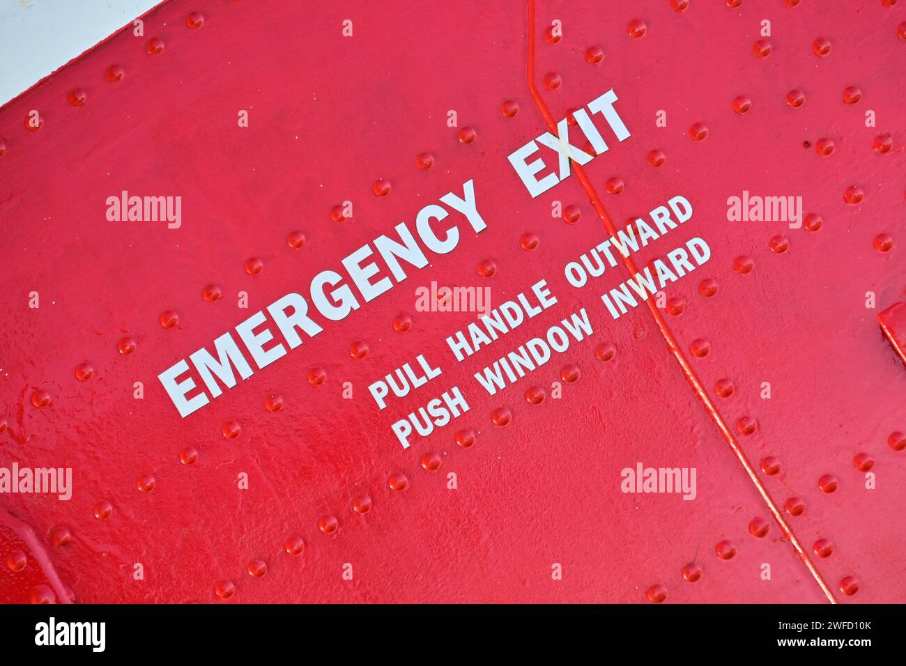 Emergency exit sign and instructions on outside of old passenger ...