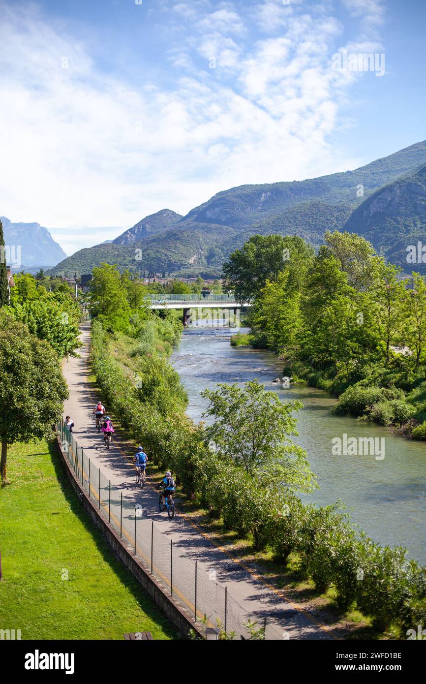Arco di Trento, bike path with cyclists and river. Trentino Alto Adige ...