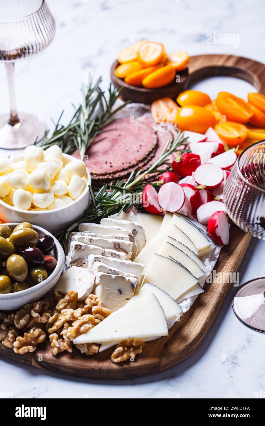 Cheese platter with meat, snacks, vegetables and nuts Stock Photo - Alamy