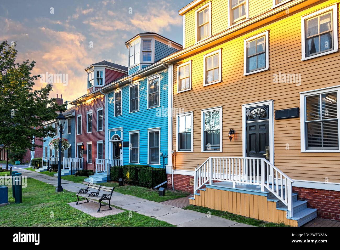 The sun sets on a row of the colorful Victorian clapboard houses in ...