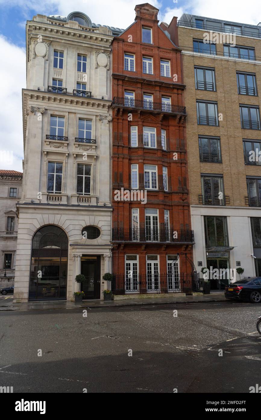Couple of narrow, tall buildings on St. James's Square in London, UK ...