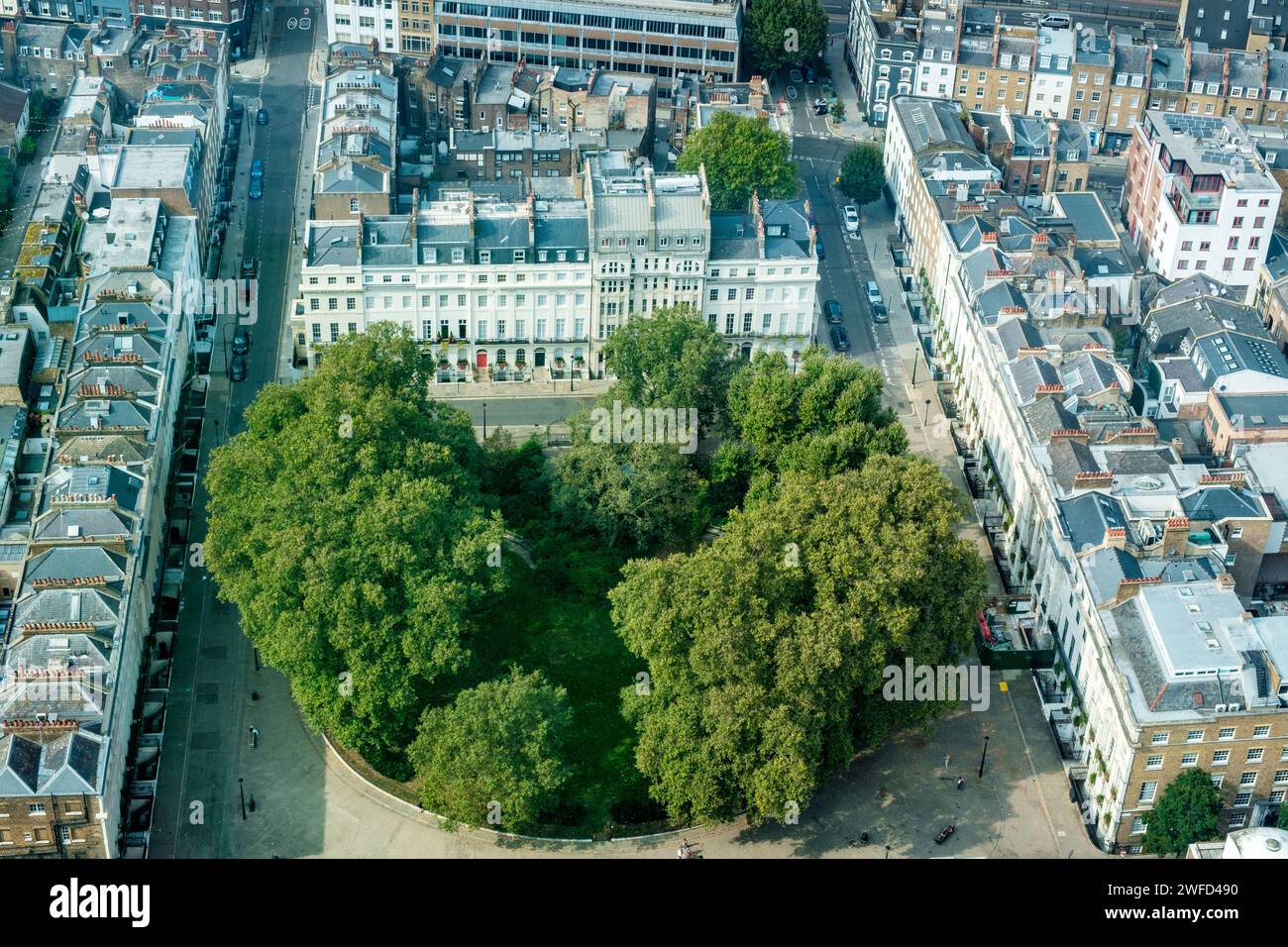 Aerial view to the North of leafy iron-fenced city square Fitzroy ...