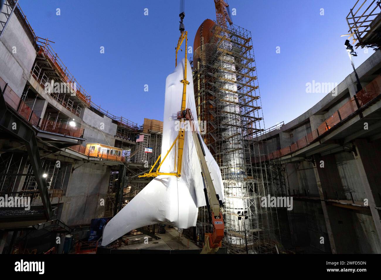 Workers finish fastening the Space Shuttle Endeavour at the site of the ...