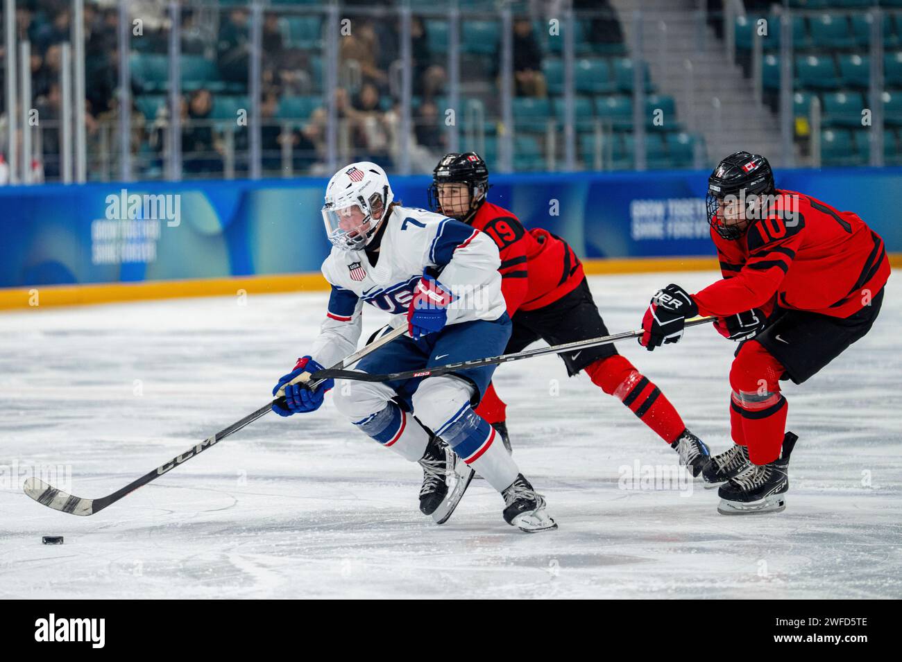 Shaeffer Gordon-Carroll, of USA skates with the puck while under ...