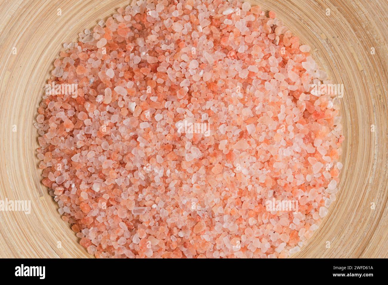 Pile of pink salt wooden background Stock Photo - Alamy