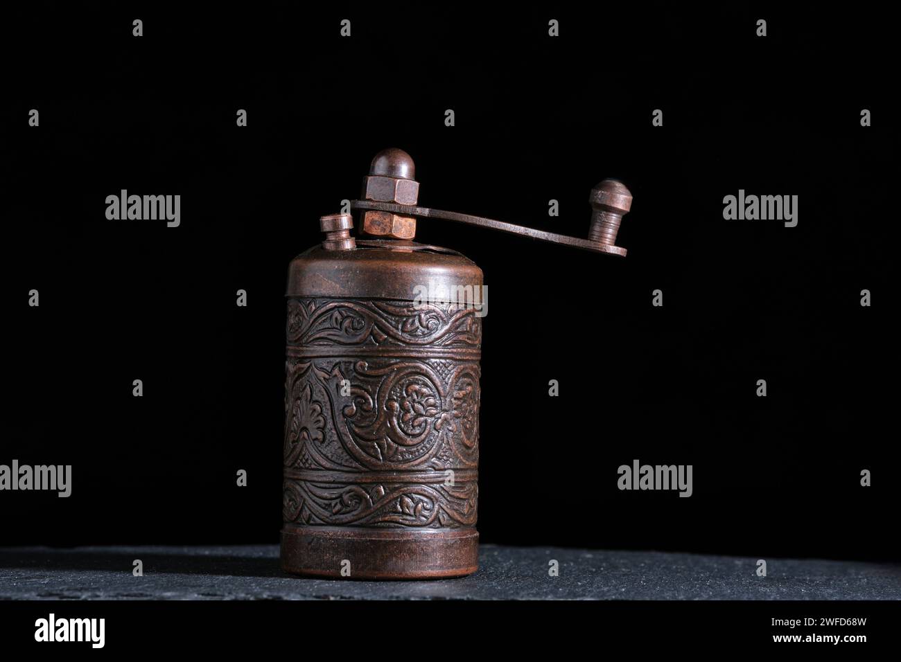 Vintage copper spice grinding mill black background Stock Photo - Alamy