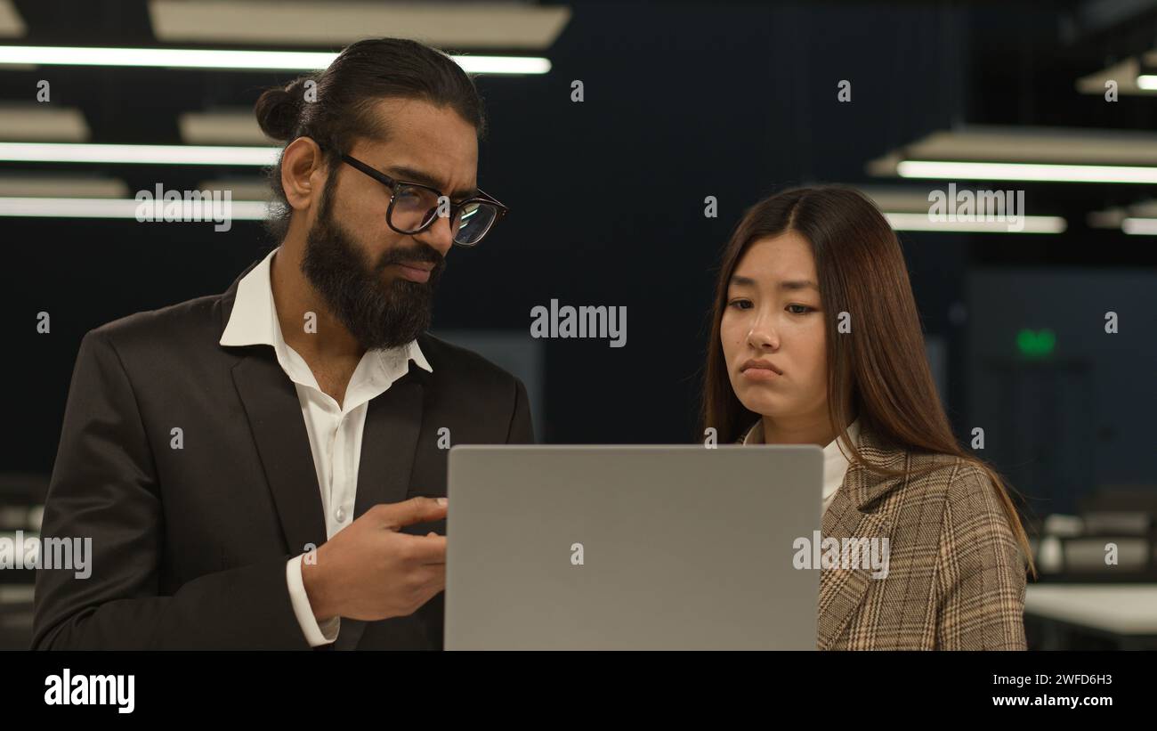 Indian businessman boss leader reprimanding Korean female Asian sad ...