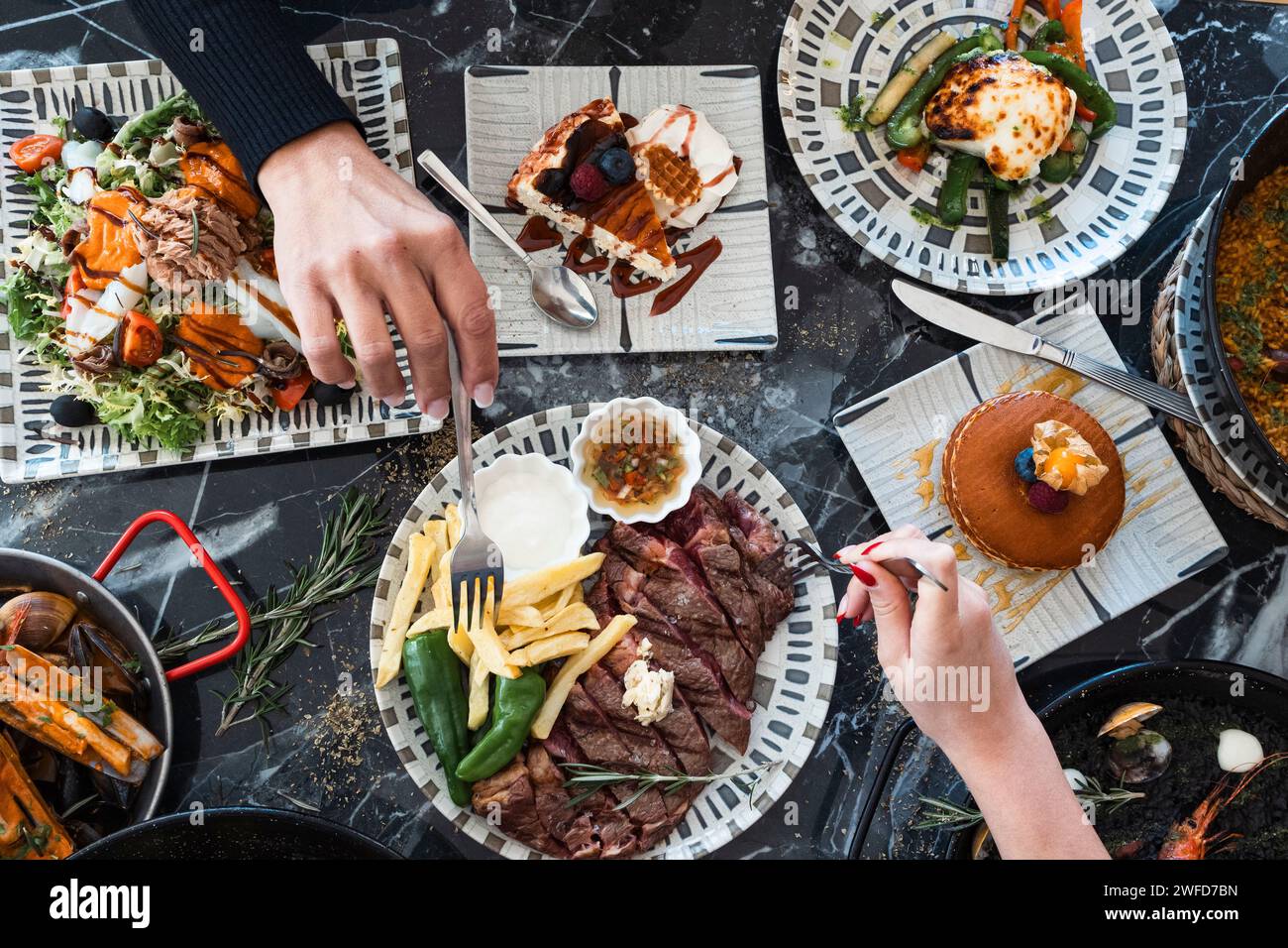 Overhead view of two women eating at restaurant table Stock Photo - Alamy