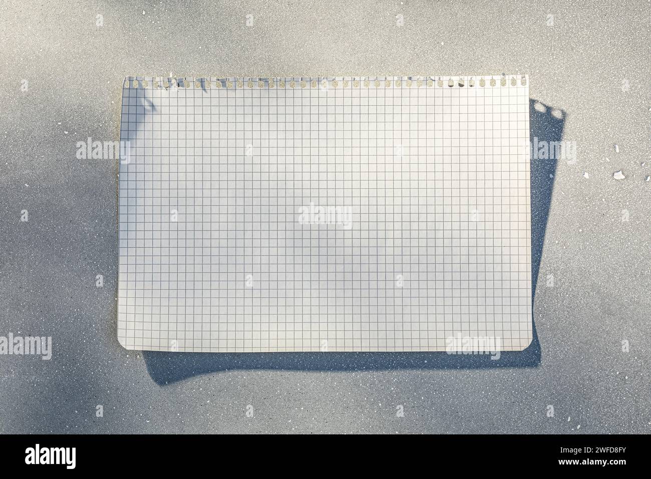 Blank Note Graph Paper Lying on a Stone Surface Under Daylight Stock ...