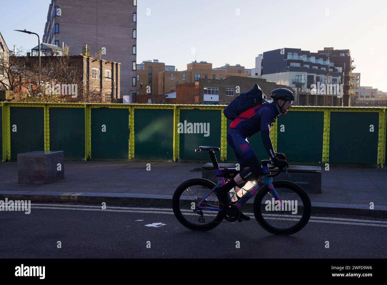 A bike rider commutes in Hackney, East London in the early morning ...
