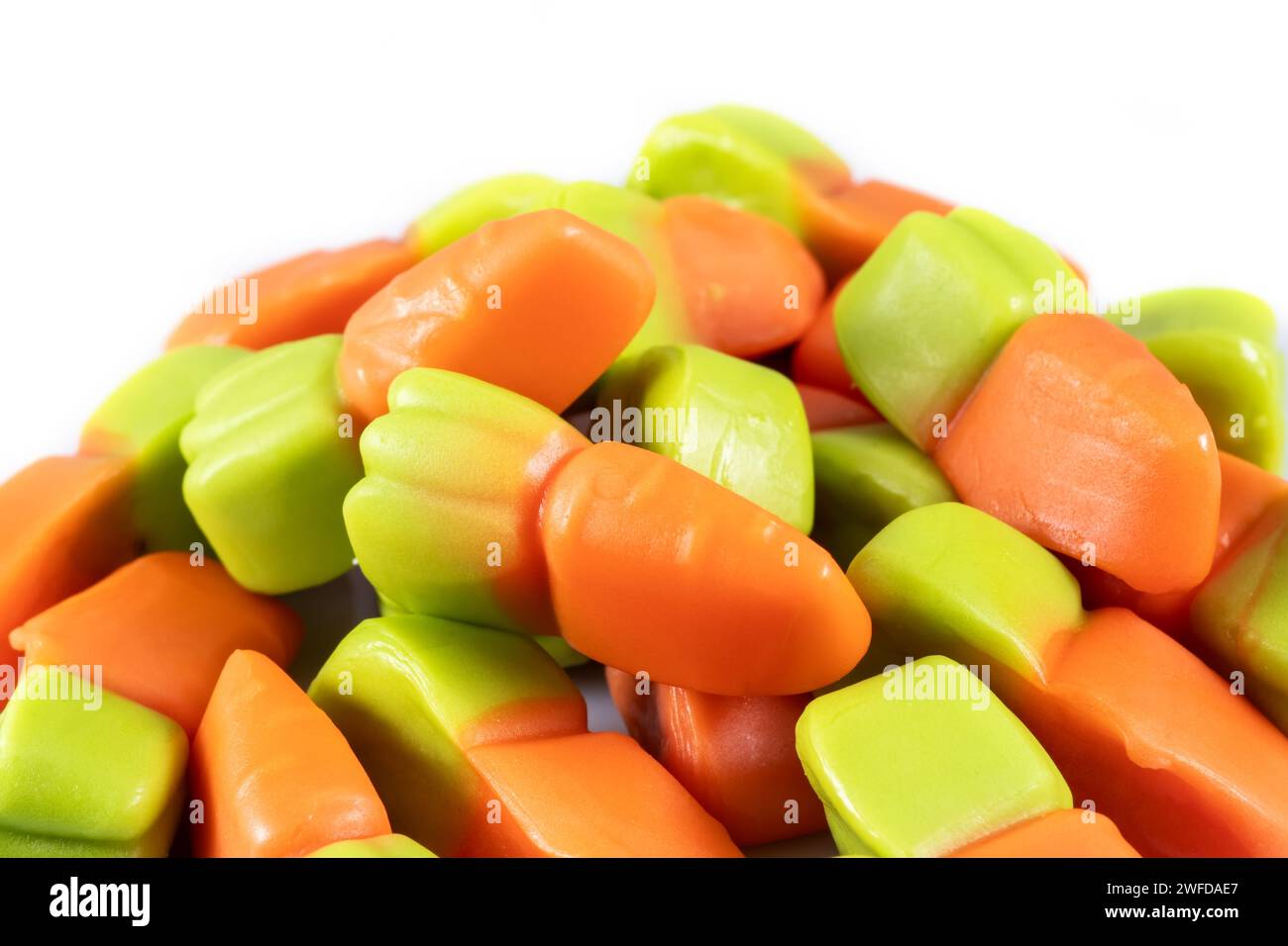 jelly carrots candies on a white background. Colorful fruit gum candies ...