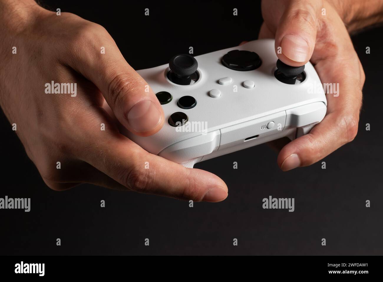 White next gen controller in man hands on dark background Stock Photo ...