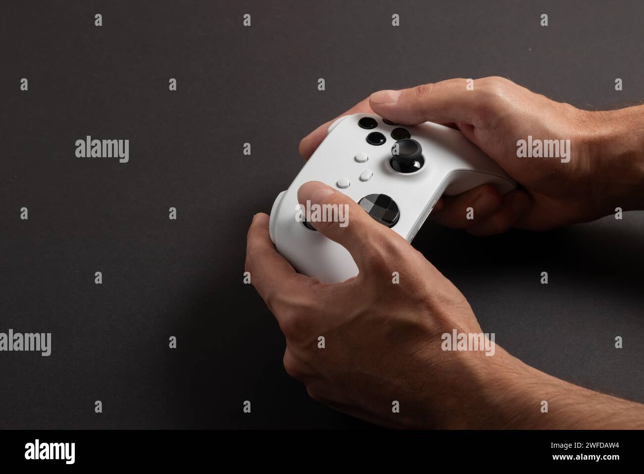 White next gen controller in man hands on dark background Stock Photo ...
