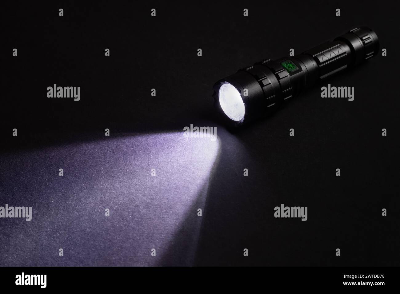 Flashlight and beam of light on a dark background Stock Photo - Alamy