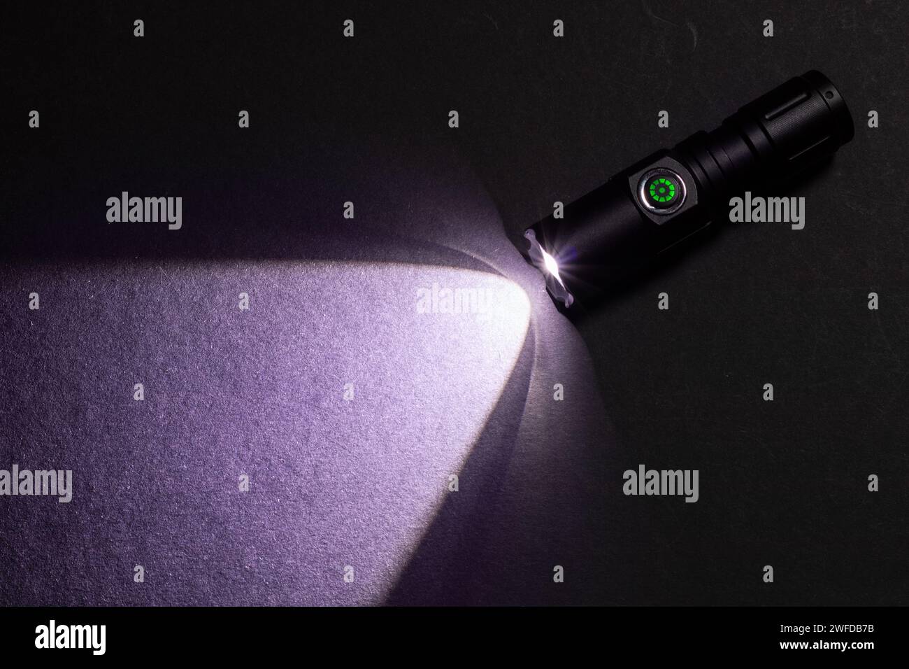 Flashlight and beam of light on a dark background Stock Photo - Alamy