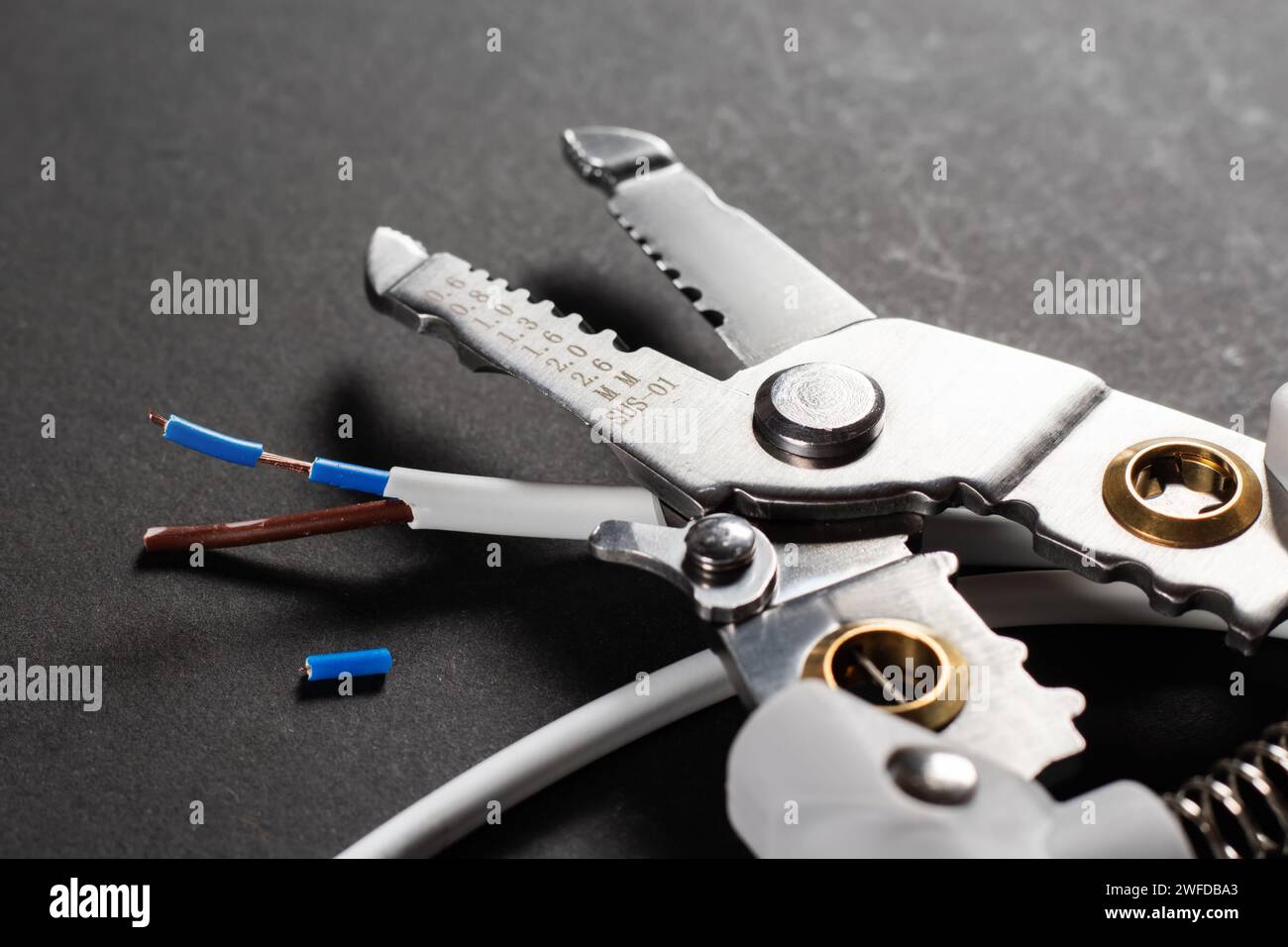 Removing the insulation from the conductor using a tool. Wire stripping ...
