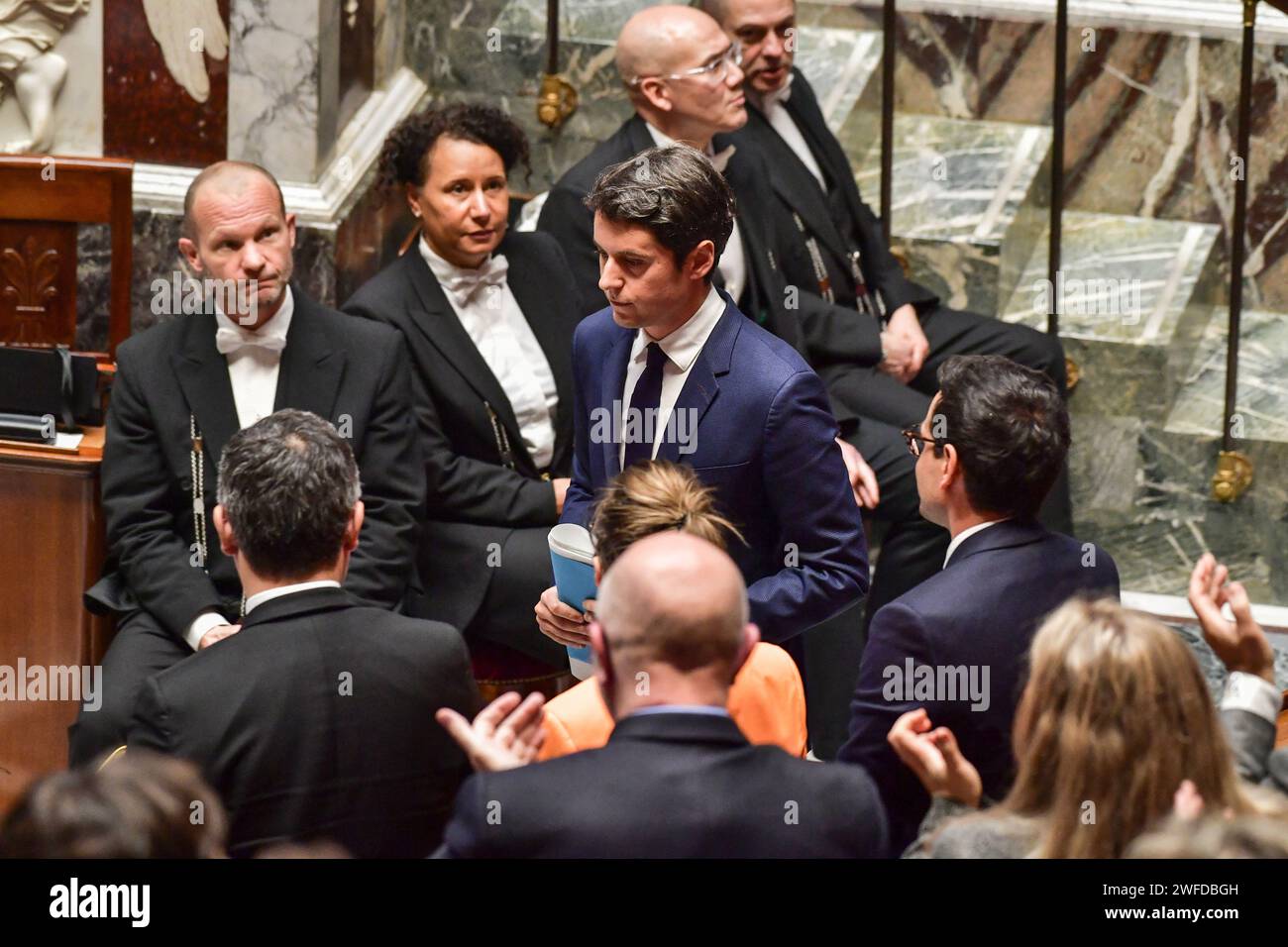 French Prime Minister Gabriel Attal walks down the podium after he ...