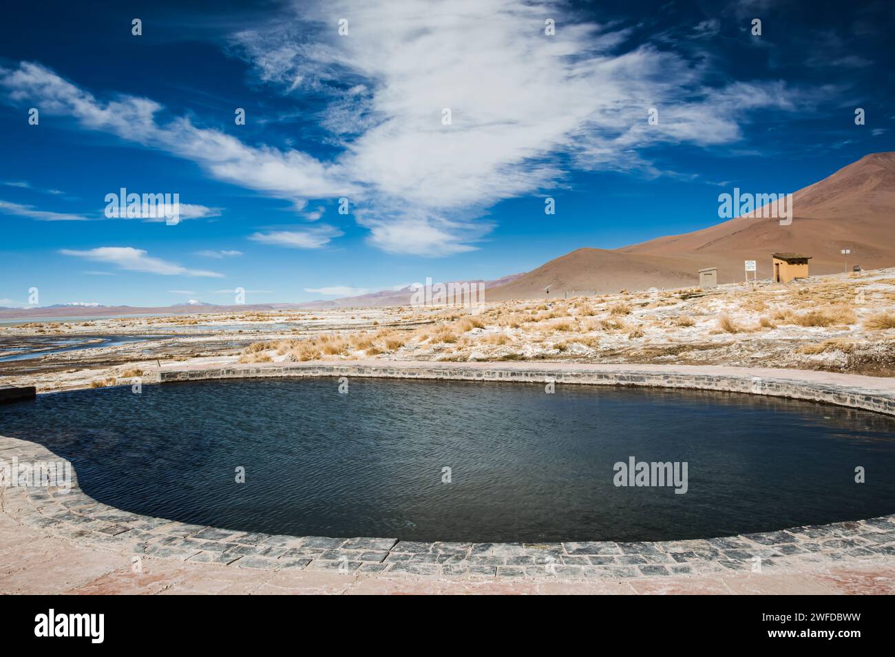 Polques thermal hot spring pool with Salar De Chalviri In the ...