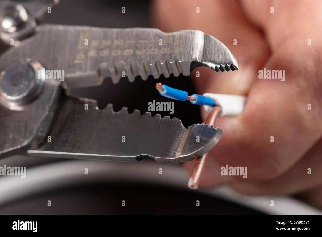 Close-up of a stripped ground wire by a wire stripper Stock Photo - Alamy