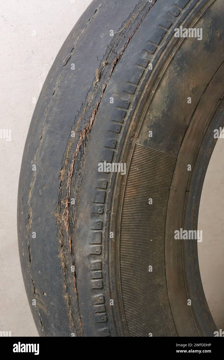 close-up of old worn out tire surface with exposed metal codes ...
