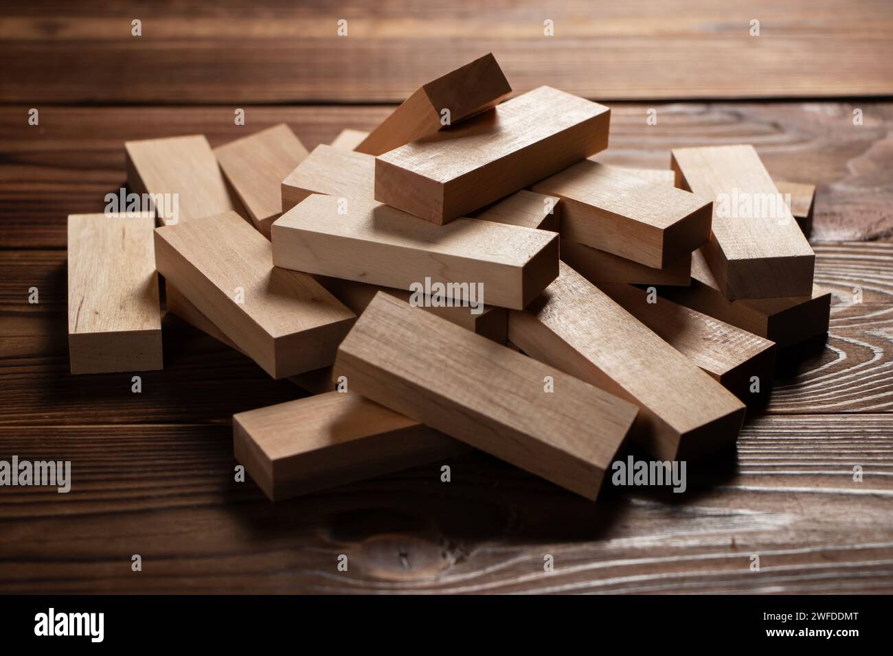 Heap of wooden blocks tower game on wood background Stock Photo - Alamy