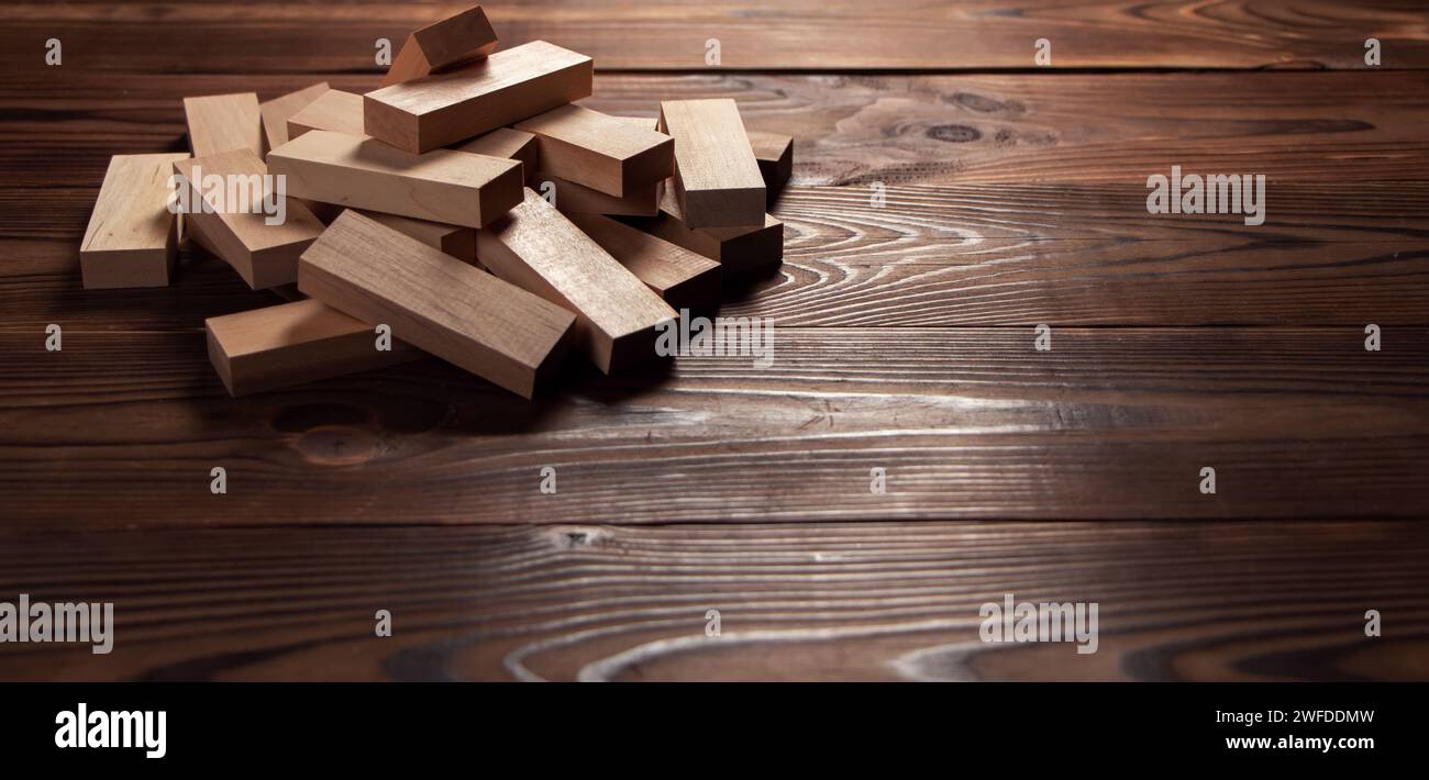 Heap of wooden blocks tower game on wood background Stock Photo - Alamy