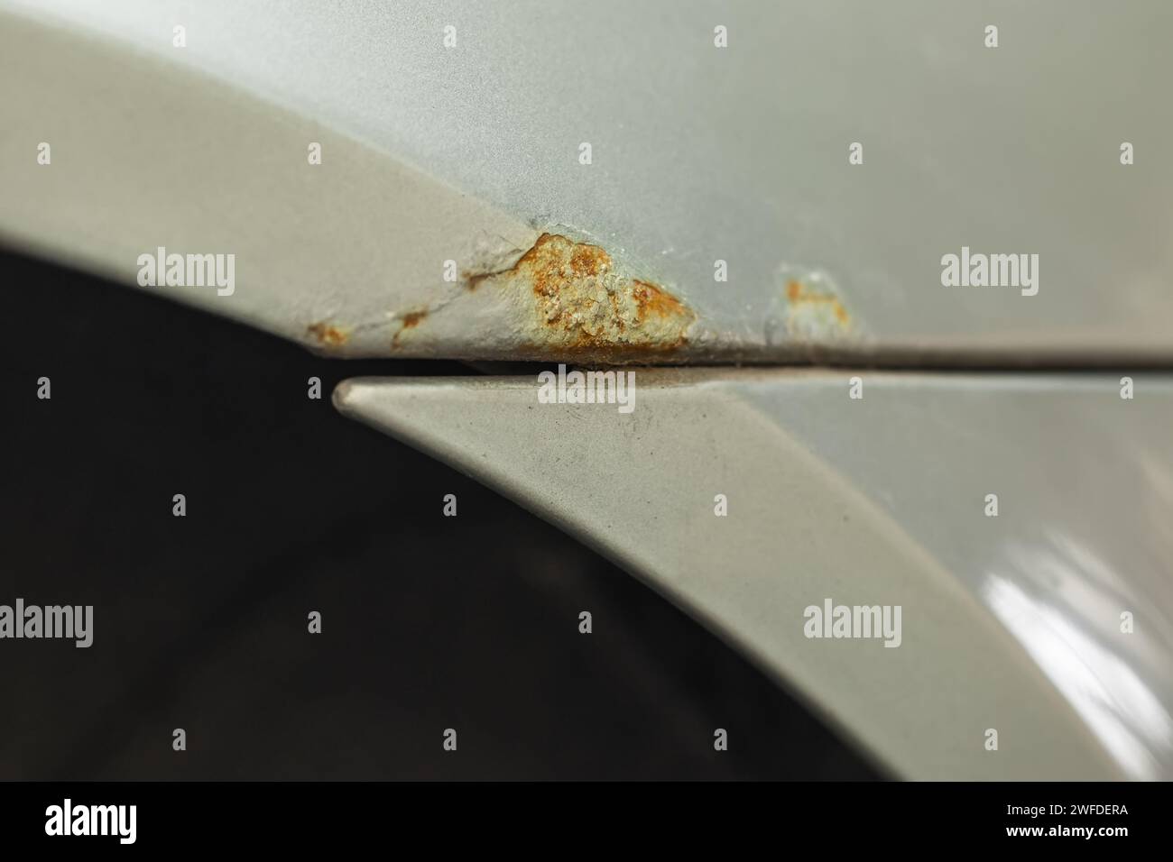 Corrosion of metal on a car body, close up. Rust on the car door ...