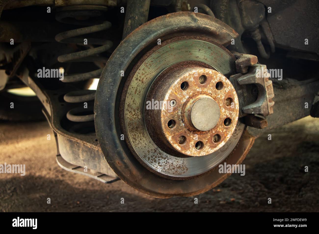 Rusty brake discs on an abandoned car. Object illuminated with soft ...
