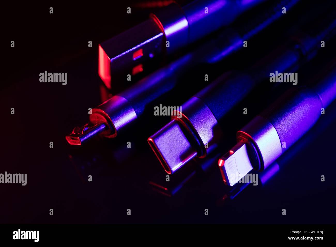 Different USB charging plugs on dark background. USB Type C, Micro USB ...