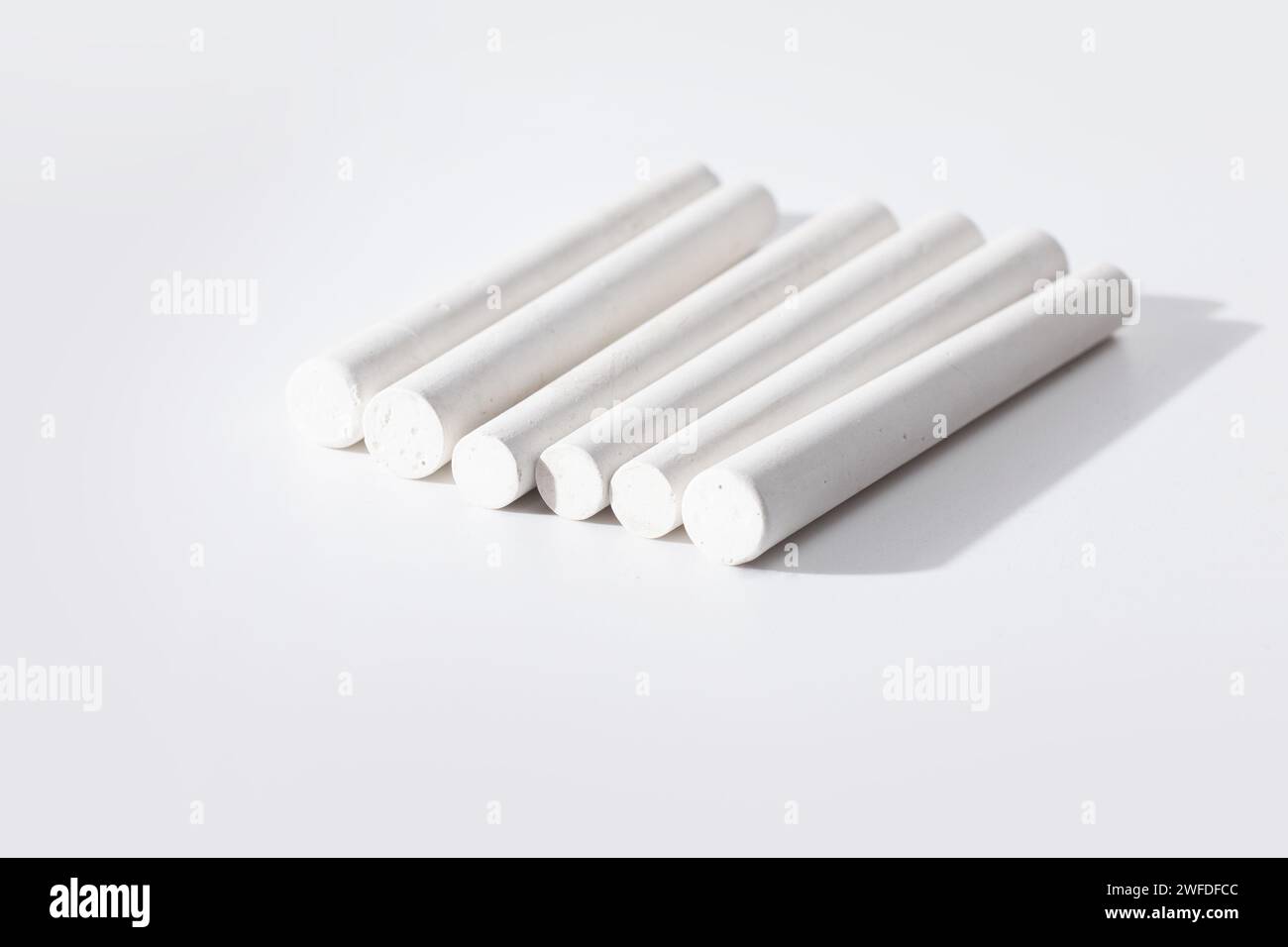 white chalk sticks isolated on white background Stock Photo - Alamy