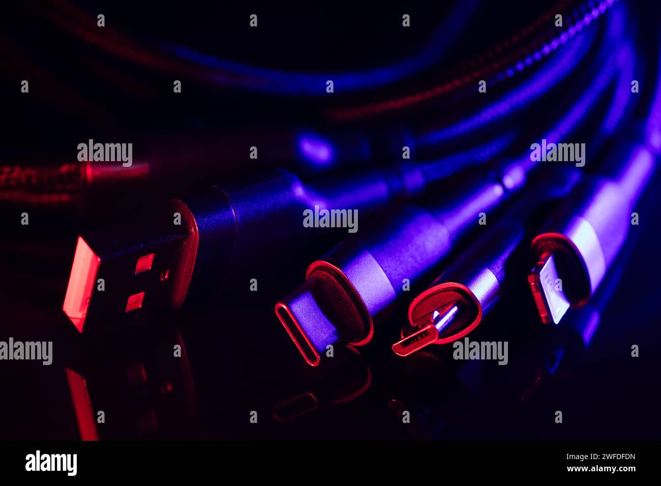 Different USB charging plugs isolated on dark background. USB Type C ...