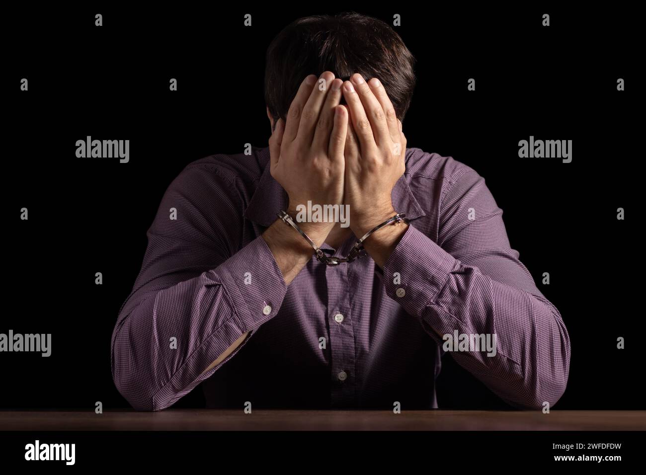 Businessman arrested for corruption. Man in a suit with handcuffs on ...