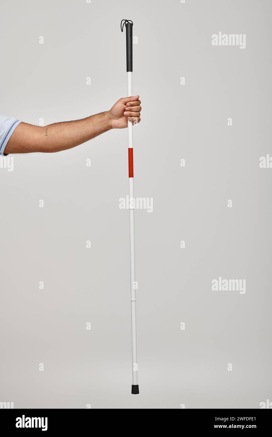cropped view of disabled indian man in blue tee shirt holding his ...