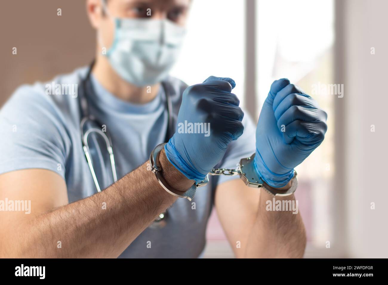 Doctor handcuffed, hands close-up, concept of medical corruption ...