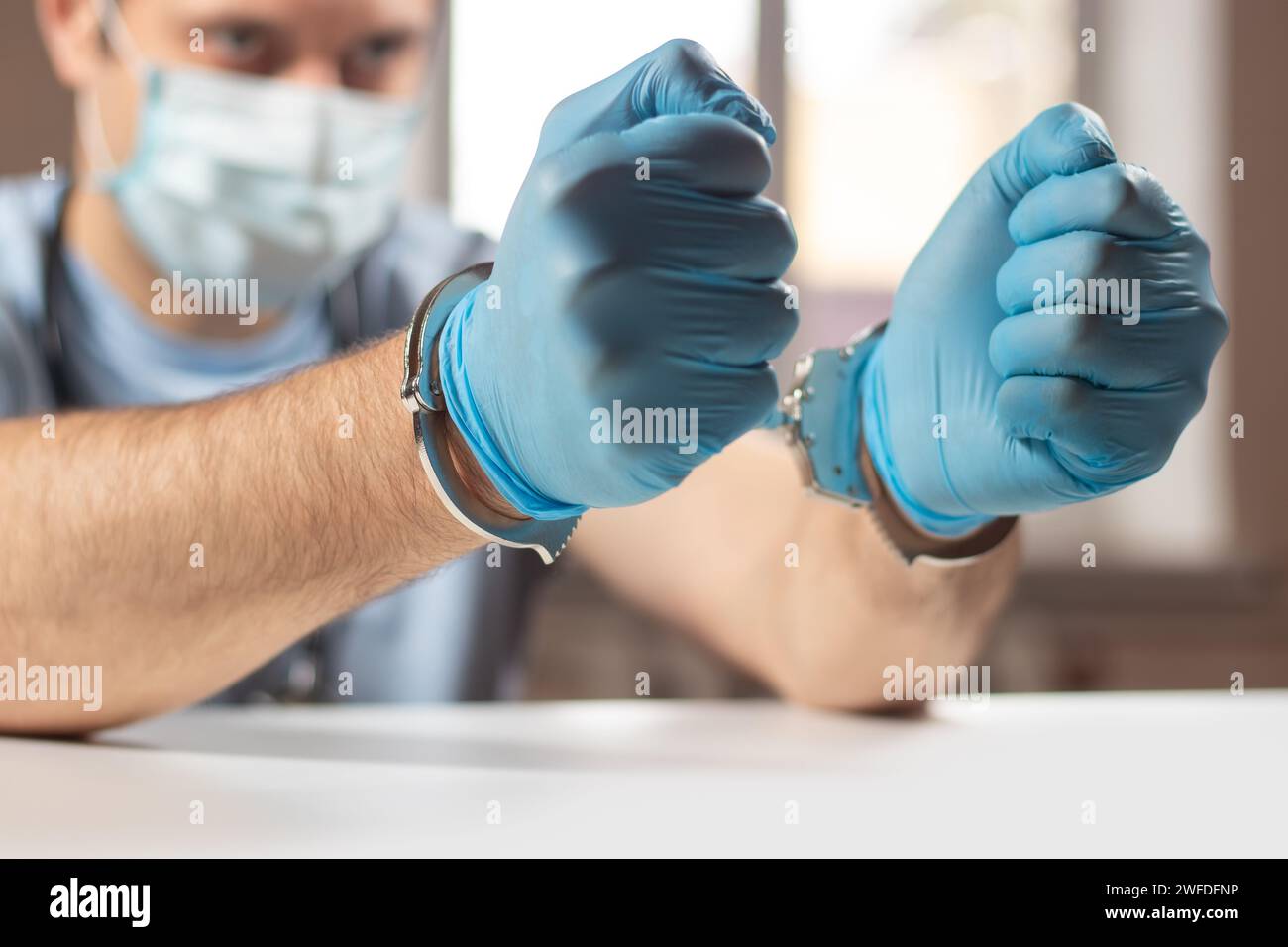 Handcuffed hands hi-res stock photography and images - Alamy