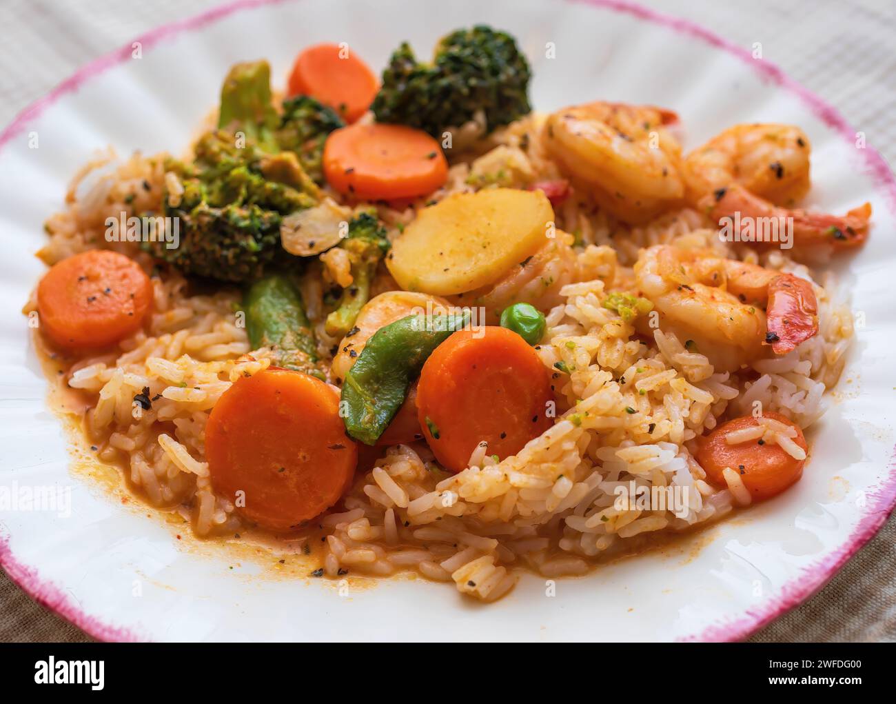 Red curry shrimp and assorted mixed vegetables over jasmine rice on a ...