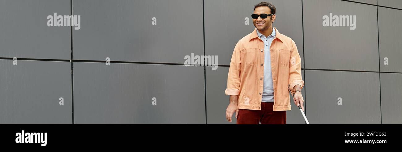jolly indian blind man in jacket with walking stick and glasses with ...