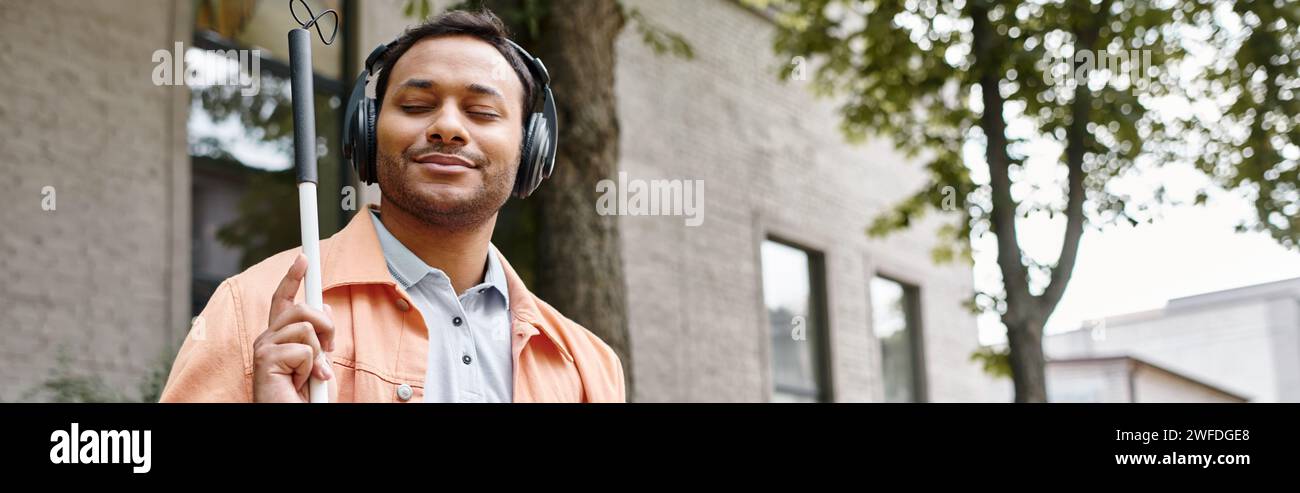 joyful indian blind man in headphones with walking stick enjoying music ...