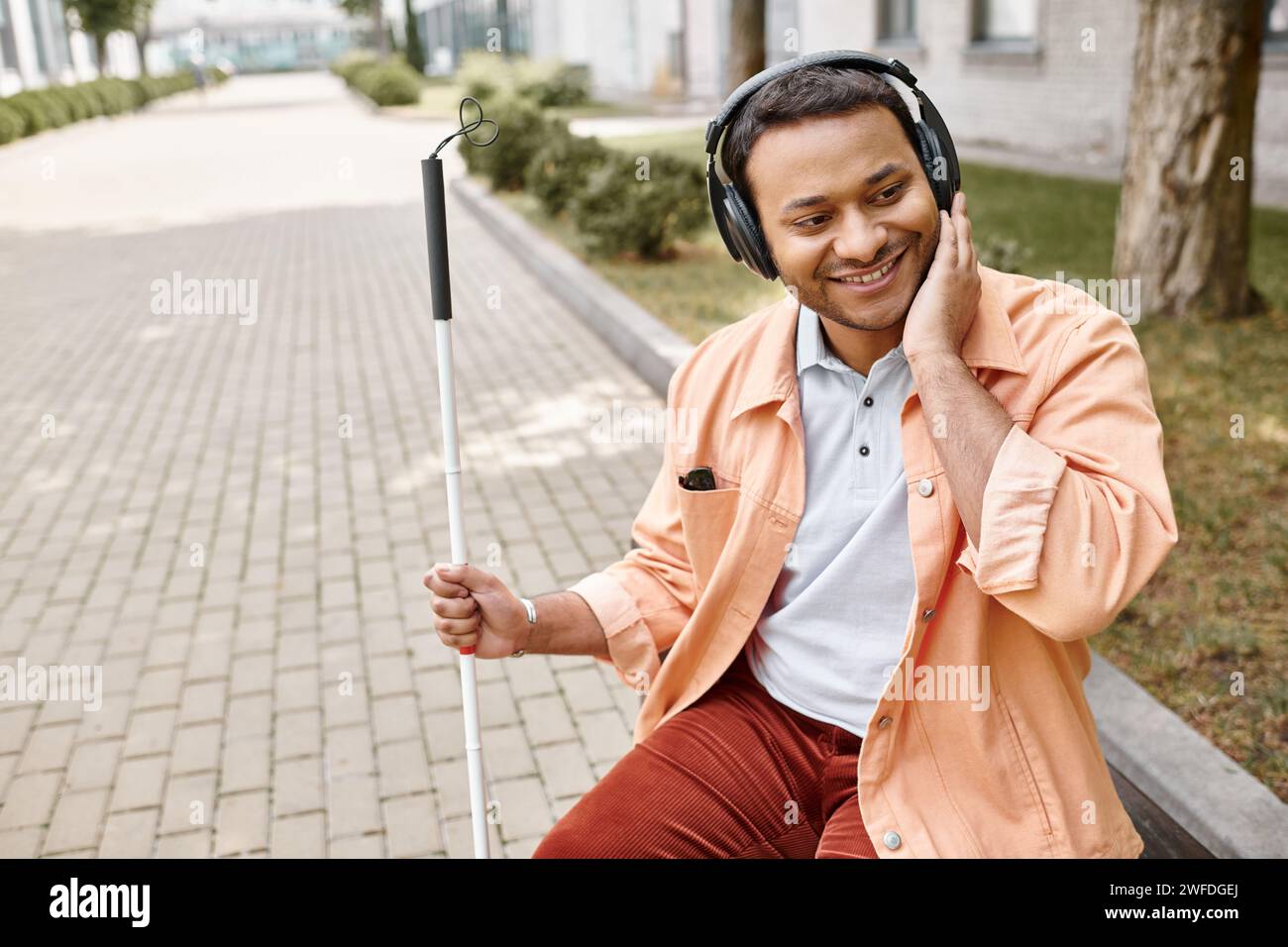 cheerful disabled indian man in casual outfit with headphones and ...