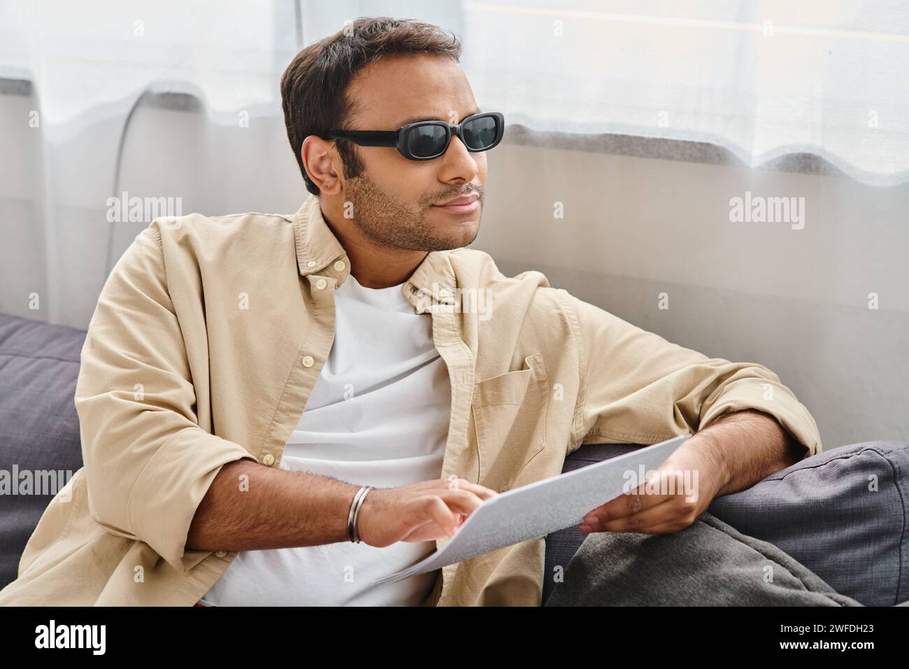good looking indian man with blindness in cozy outfit sitting and ...
